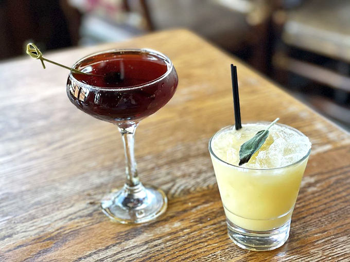 Cocktails that belong in a painting&mdash;one ruby-red and mysterious, the other sunshine-yellow with a sprig of sage. Art in liquid form.