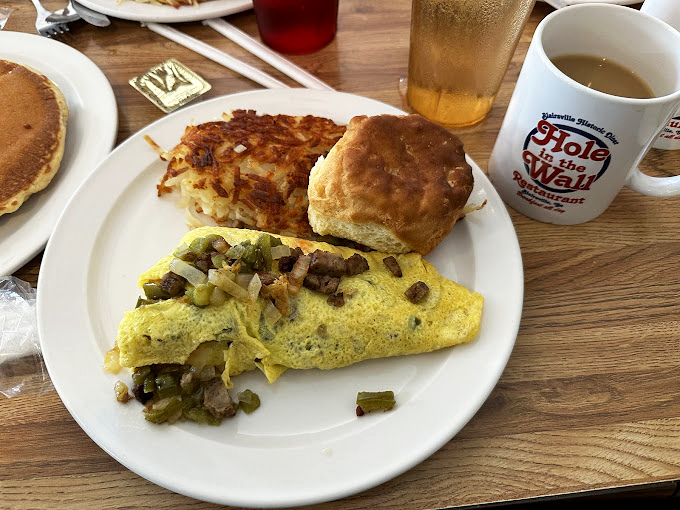 The breakfast plate that launched a thousand road trips &ndash; an omelet stuffed with possibility, hash browns crisp at the edges, and a biscuit begging for butter.