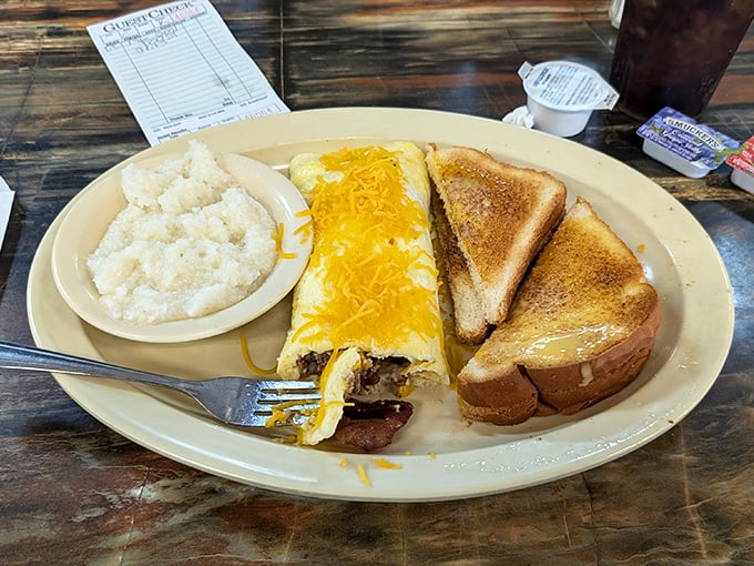A cheese omelet, buttery toast, and grits that would make any Southerner proud. The holy trinity of breakfast, Alabama-style.
