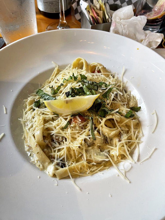 Pasta that doesn't just sit on the plate&mdash;it performs! Parmesan snowfall, fresh herbs, and that lemon wedge waiting to brighten everything up.