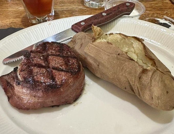 The bacon-wrapped filet: where butter-tender beef meets crispy pork in a romance that would make Shakespeare weep with joy.