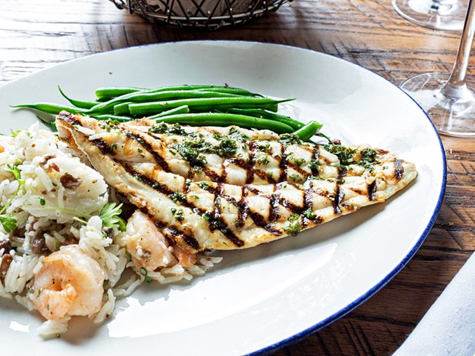 Perfectly grilled fish alongside shrimp-studded rice&mdash;proof that coastal Carolina cuisine is poetry on a plate.