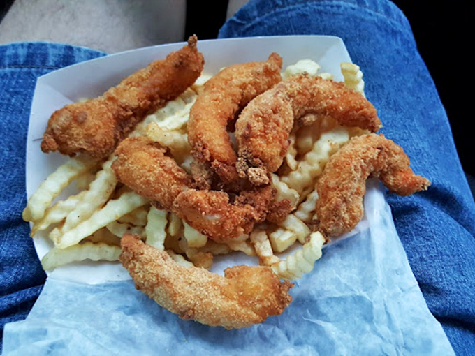 A marriage made in culinary heaven: crispy golden shrimp nestled against hot, perfectly cooked fries. Simple pleasures are often the best.