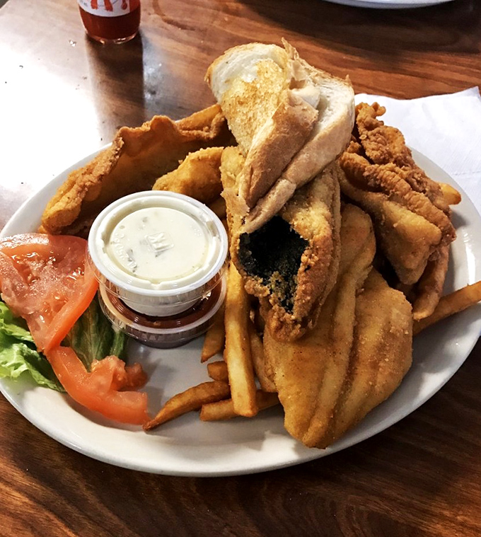 A fish sandwich that requires both hands and several napkins. The bread is just there to give your fingers something to hold onto.