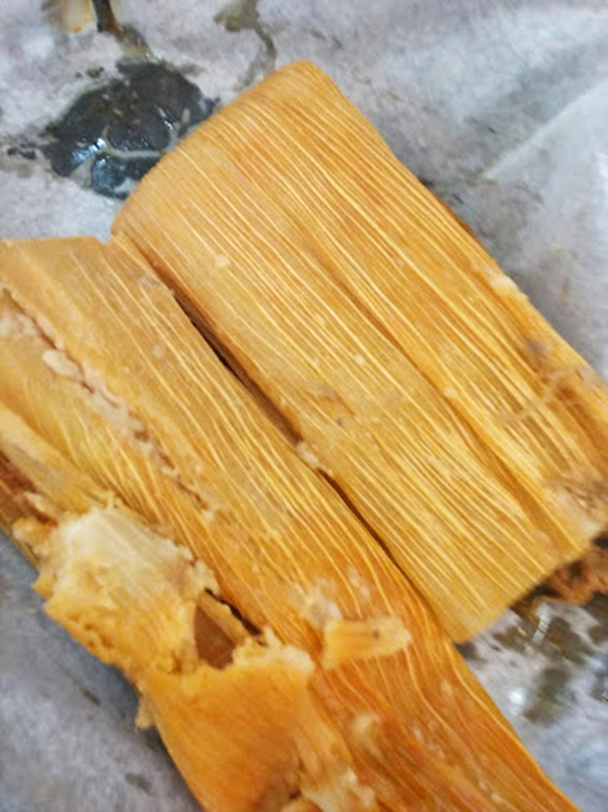 Unwrapped tamales reveal their golden glory. Like nature's perfect to-go food, these have been steamed to tender perfection.
