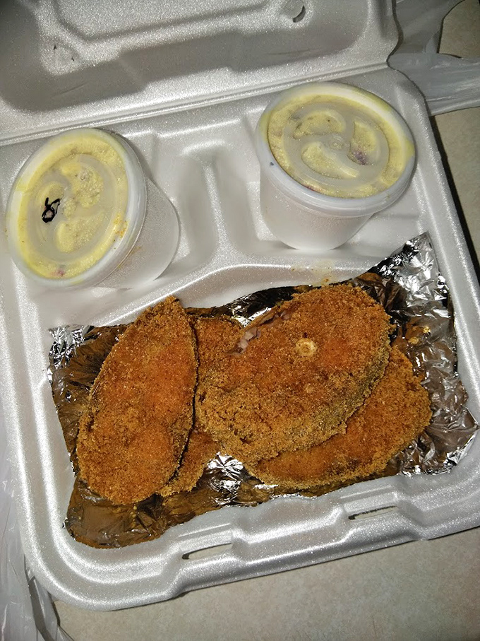 The styrofoam might be humble, but what's inside is pure gold - catfish with the ideal crispy exterior that shatters just right with each bite.