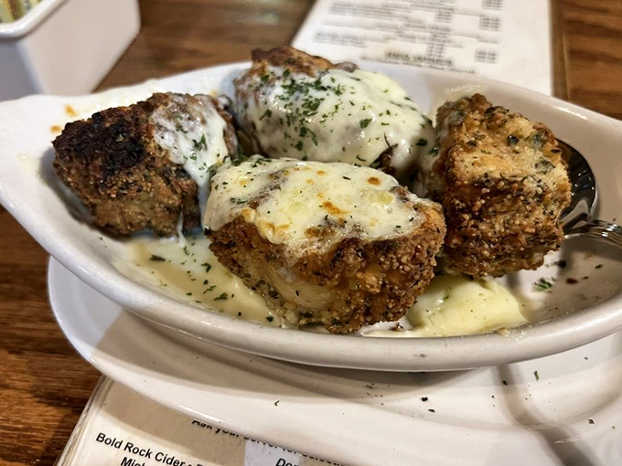 These aren't your average mushrooms&mdash;they're little flavor bombs, breaded and fried to golden perfection, then smothered in melty cheese goodness.