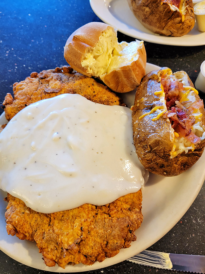 Southern comfort meets steakhouse expertise&mdash;a chicken fried steak smothered in peppery cream gravy alongside potatoes that have achieved their highest purpose.