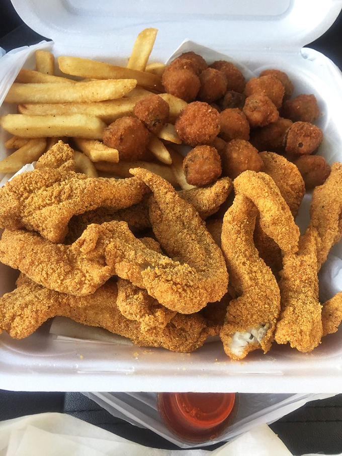 The holy trinity of Midwestern happiness: golden catfish strips, perfect hush puppies, and fries that make you forget you're 500 miles from any ocean.