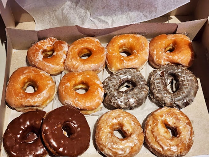 The box reveals a dozen reasons to skip your morning meeting. That glazed donut in the corner is practically winking at you.