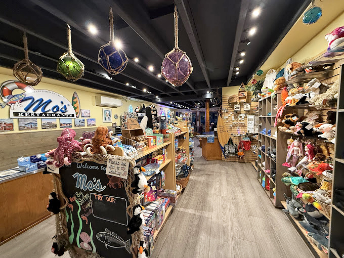The gift shop at Mo's proves that seafood obsession extends beyond mealtime, with colorful buoys and coastal treasures for your home.