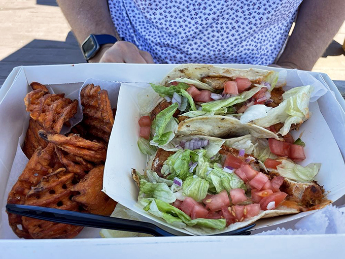 Fish tacos that make you question why you'd eat anything else &ndash; fresh grouper, crisp lettuce, and diced tomatoes in perfect harmony.