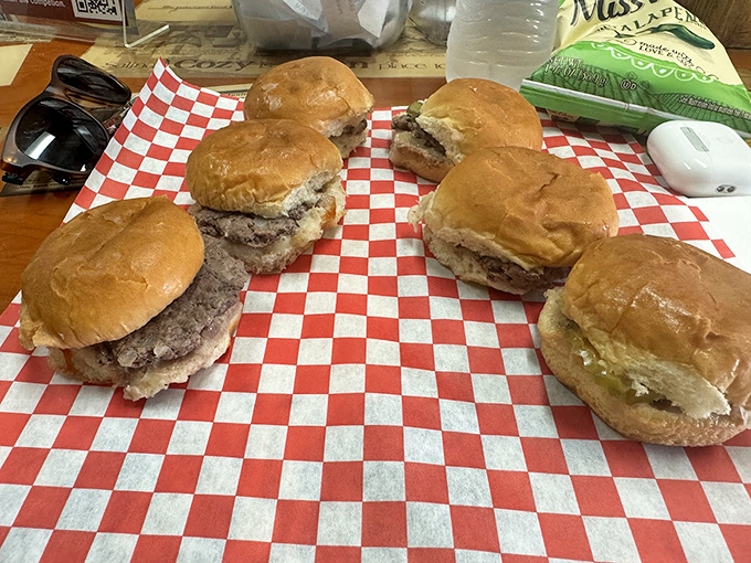 A red-checkered paper holds the holy grail of slider enthusiasts. Six little burgers, six big flavor bombs.