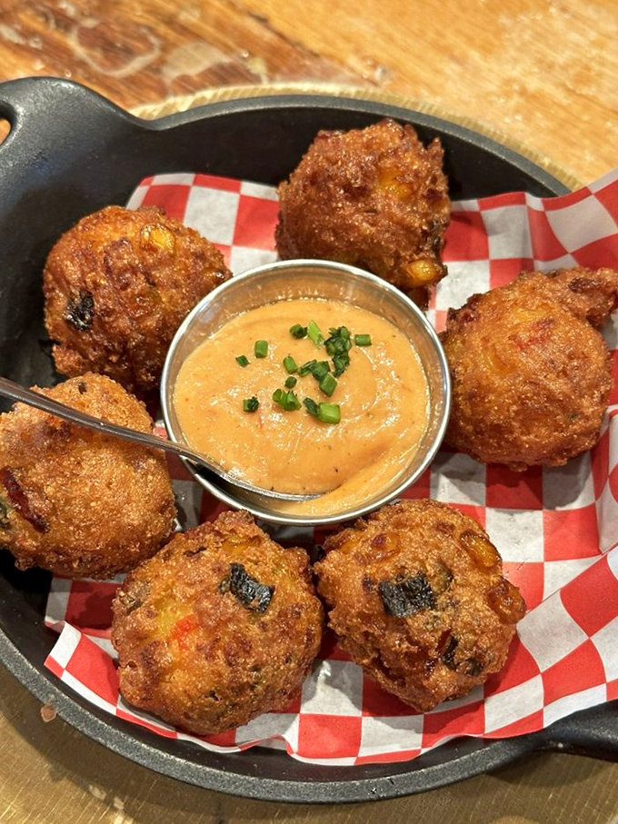 These hush puppies aren't keeping quiet about their deliciousness. Crispy exterior, tender interior, and that dipping sauce is playing all the right notes.