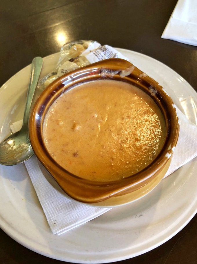This isn't just soup—it's a warm hug in a bowl. The lobster bisque's rich amber color promises comfort with every spoonful.
