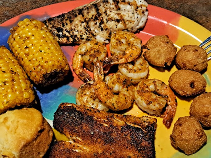 A seafood sampler that hits all the right notes: blackened fish, grilled shrimp, and hushpuppies. The corn on the cob is just showing off.
