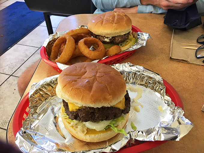 The burger-onion ring combo plate: where circular food geometry creates the perfect equation for satisfaction.
