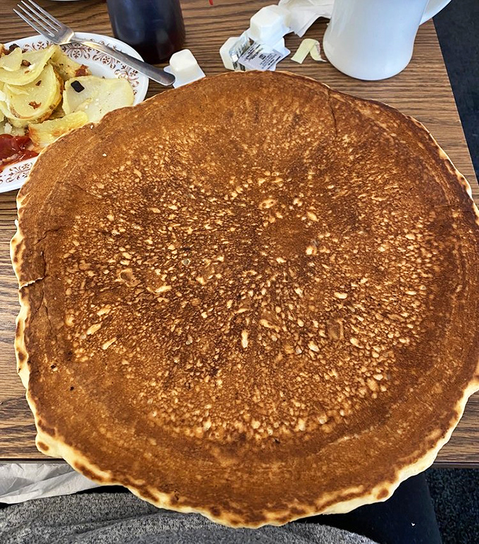 The pancake that ate Fredericktown! This golden-brown beauty spans the plate like a delicious solar eclipse, making syrup manufacturers everywhere rejoice.