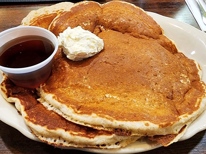Pancakes so fluffy they could double as pillows, with butter melting into golden pools of breakfast bliss. Maple syrup not optional, but absolutely essential.