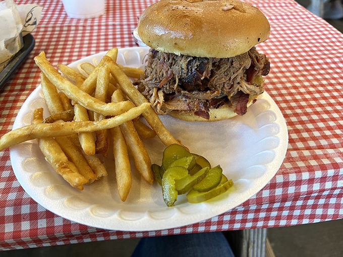 The sandwich that launched a thousand napkins&mdash;pulled pork and brisket stacked higher than your cardiologist's blood pressure.