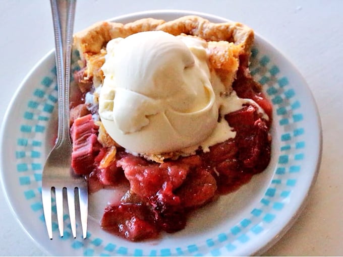 A slice of rhubarb pie topped with ice cream&mdash;proof that sometimes the best things in life require a fork and zero restraint.