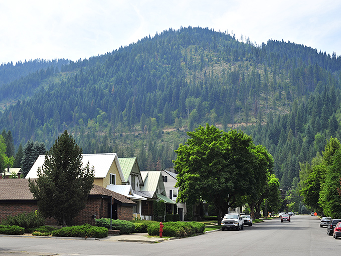 The residential streets of Wallace nestle against mountain slopes like they're trying to get a better view of their own charming downtown.