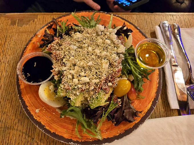 A salad that actually deserves its place at the table. Those crumbles of cheese are playing hide-and-seek among greens that were probably picked this morning.