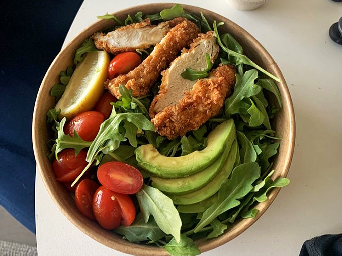 Even the salads here mean business – crispy chicken, fresh greens, and avocado slices that make you forget you ordered the "healthy option."