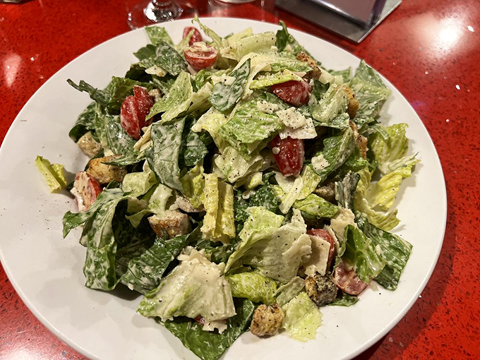 A salad that actually excites: Crisp romaine tossed with house-made dressing and fresh vegetables &ndash; the rare salad that doesn't feel like punishment.