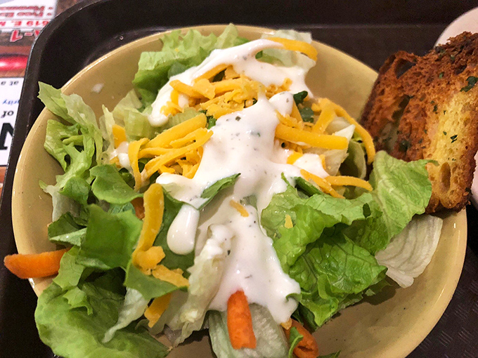 The token salad&mdash;a crisp, cheese-topped nod to nutrition that somehow makes you feel virtuous before demolishing three plates of fried catfish.