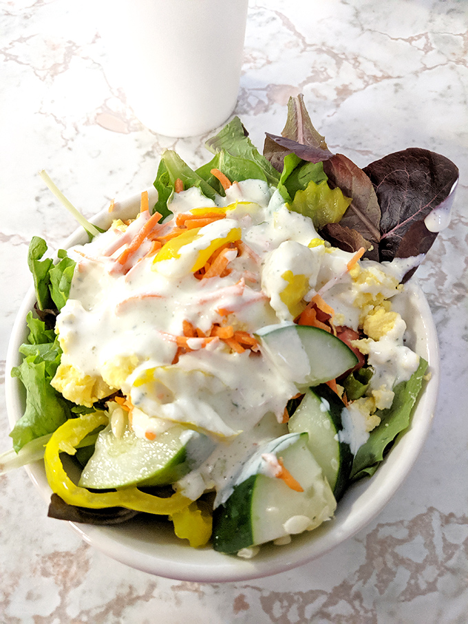 Even the salad gets special treatment here. Fresh, crisp, and dressed to impress&mdash;a refreshing counterpoint to the fried delights.