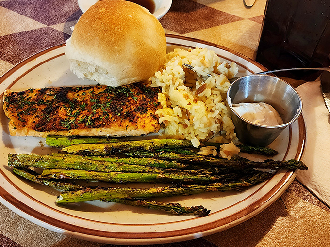 Blackened salmon that could convert even the most dedicated carnivore. Paired with grilled asparagus and rice pilaf, it's vacation on a plate.