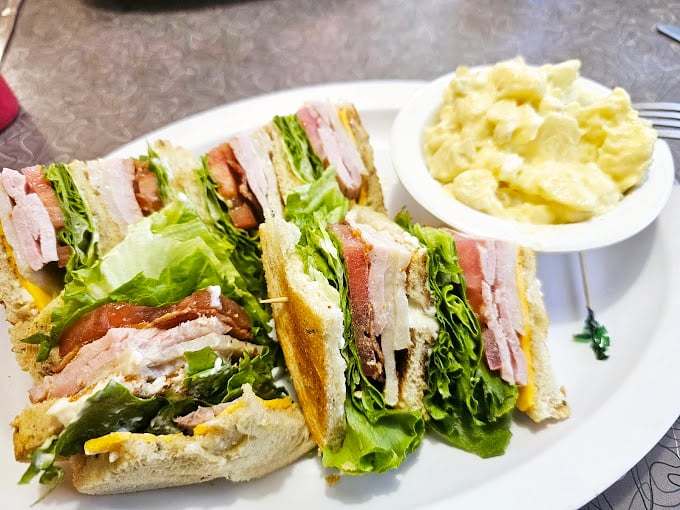 The club sandwich &ndash; architecture you can eat! Layers of fresh ingredients stacked between toasted bread with a side of potato salad that didn't come from any factory.