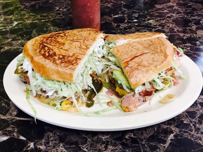 The torta &ndash; where sandwich architecture meets artistic vision. That cabbage mountain isn't just garnish; it's structural reinforcement for flavor skyscrapers.