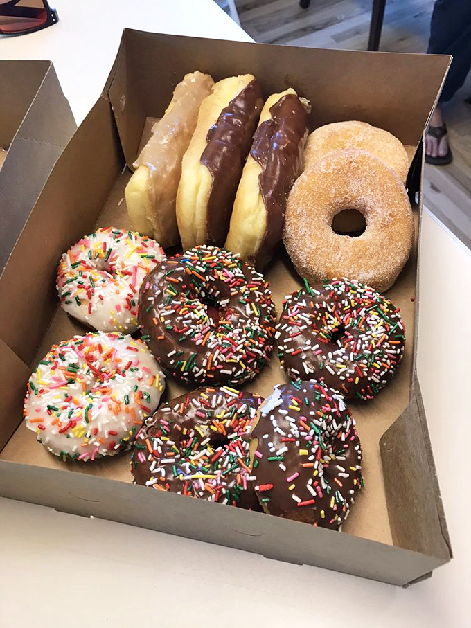 The donut rainbow in its natural habitat: a simple box that somehow transforms Monday mornings into bearable experiences.