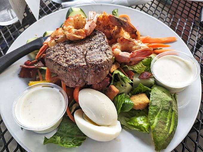 Surf meets turf in this elegant composition of steak and shrimp. The plate transforms lunch into an occasion, proving that inland Arkansas can deliver oceanside luxury.