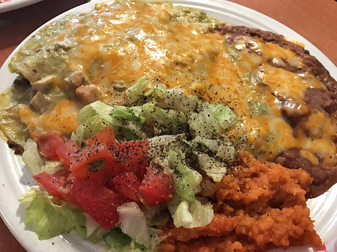 The holy trinity of Tex-Mex: perfectly melted cheese, vibrant rice, and refried beans that didn't come from any can.