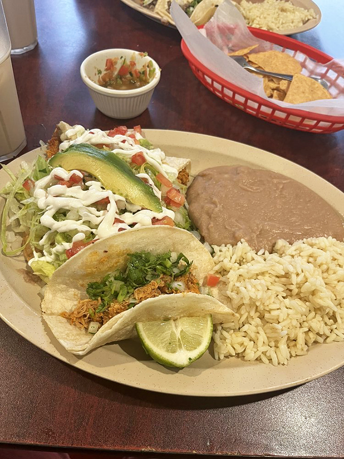 This isn't just a meal; it's a geography lesson in deliciousness with rice, beans, and tacos forming the most delicious landscape you'll ever explore.