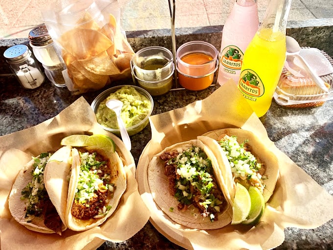 A feast for all senses: vibrant tacos adorned with fresh cilantro and onion, house-made salsas in jewel tones, and those freshly-fried chips calling your name. Resistance is futile.