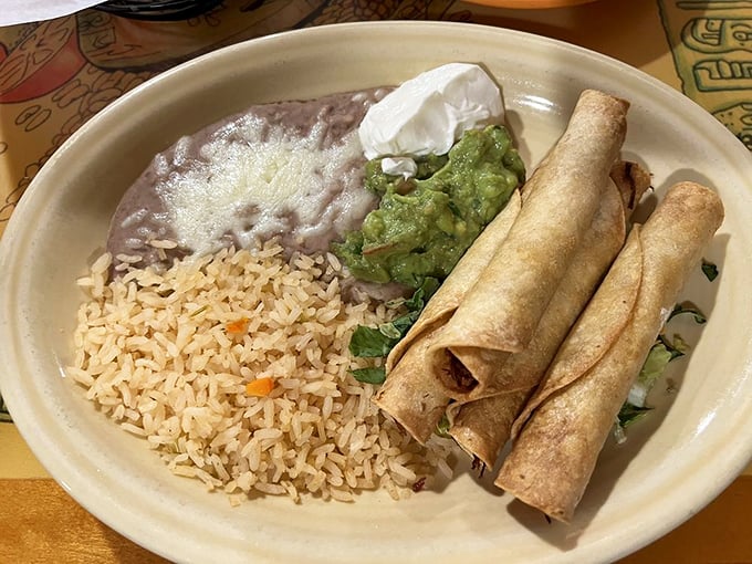 These taquitos aren't just rolled tortillas&mdash;they're flavor cylinders served with the holy trinity of rice, beans, and guacamole.