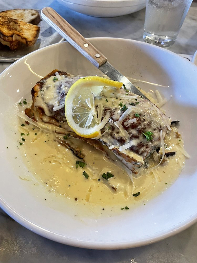 Not your nonna's lasagna, but she'd approve anyway. A slice of comfort topped with a bright lemon round and swimming in a sea of cheesy bliss.