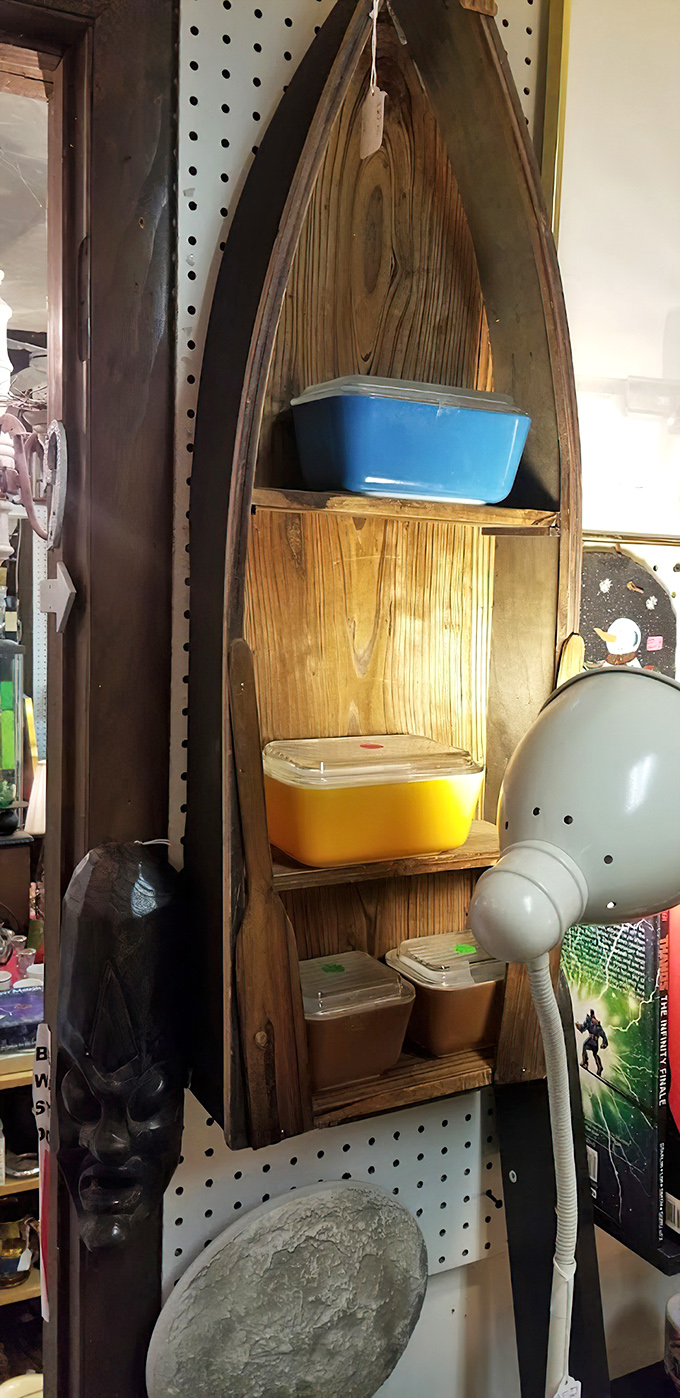 Nautical ingenuity meets practical storage in this boat-shaped shelf. Pyrex treasures nestle in wooden waves, sailing through decades of kitchen history.