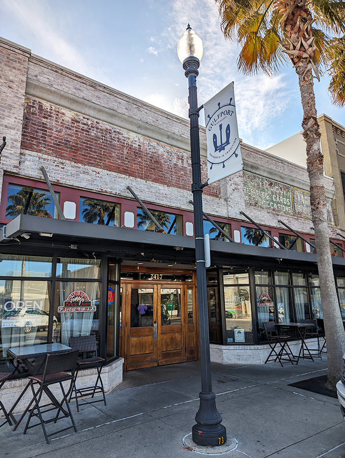 Tony's historic brick facade whispers stories of Gulfport's past. Those palm trees aren't just decoration&mdash;they're nature's "Open" sign.