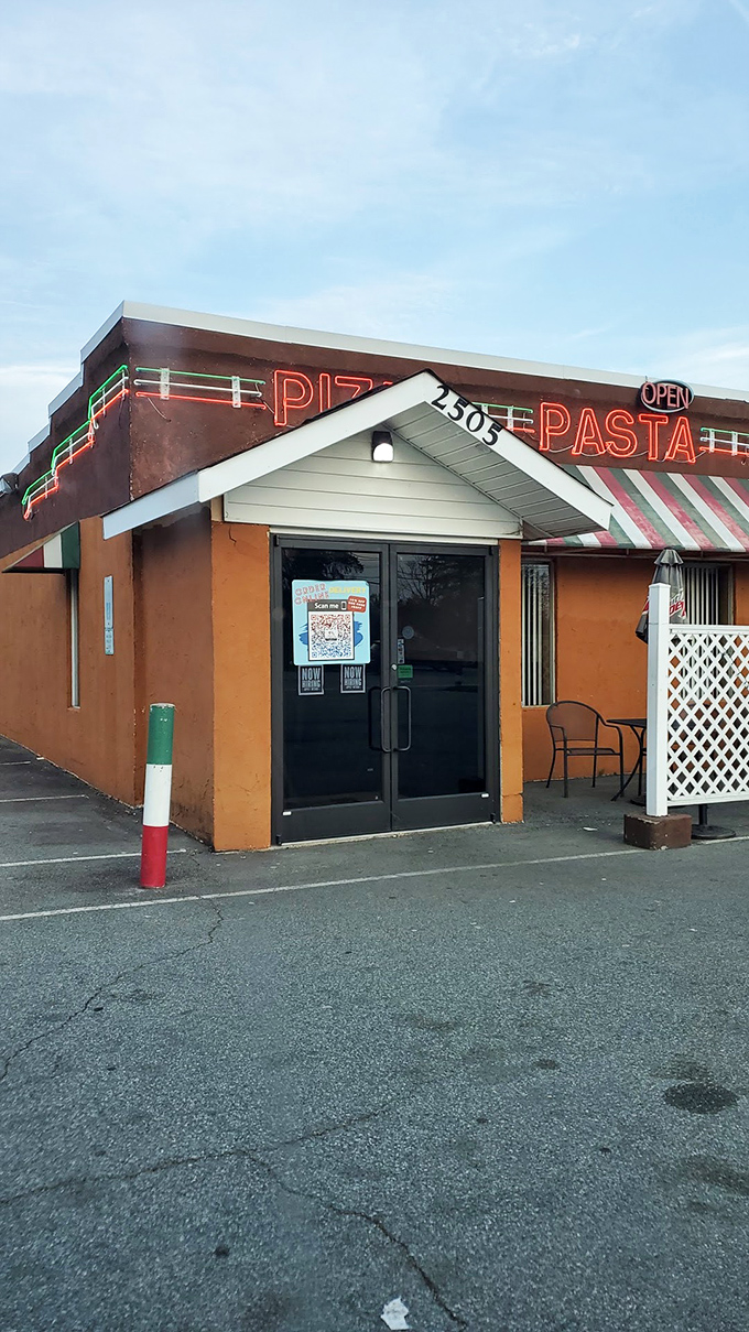 The humble orange facade might not win architectural awards, but the pizza inside deserves a trophy for "Most Likely to Make You Moan."