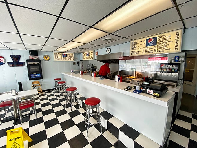 The classic checkerboard floor at Madvek's sets the stage for hot dog perfection &ndash; where every topping placement seems mathematically precise.