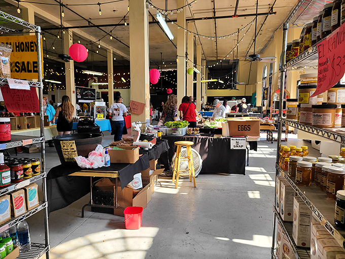 Sunlight streams through windows as vendors display local bounty. Part farmers market, part time machine, all Oklahoma charm.