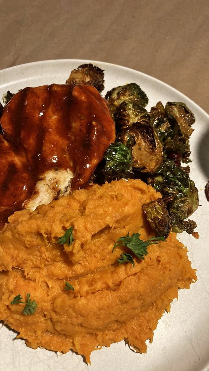 BBQ chicken glistening with tangy sauce sits beside Brussels sprouts that might convert even the most dedicated vegetable skeptics.