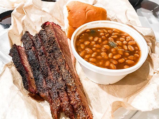 The classic pairing that proves soulmates exist: smoke-kissed brisket beside beans that have clearly been taking flavor notes.