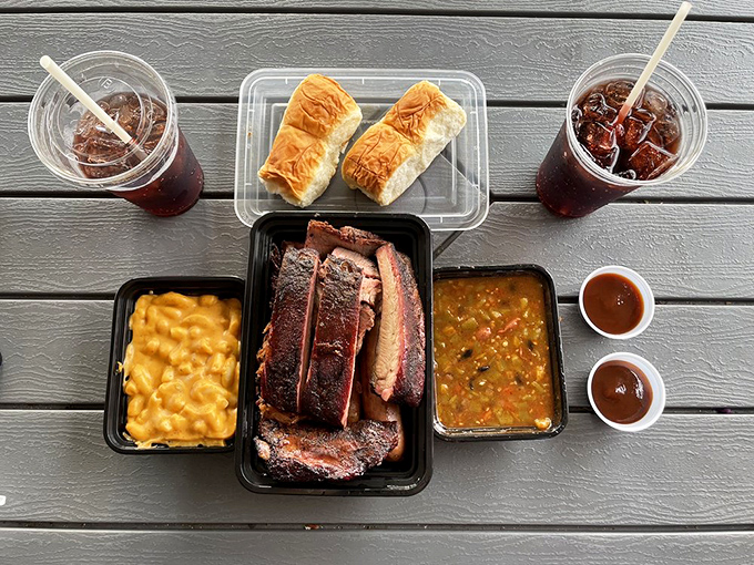 A BBQ spread that makes you grateful to be alive &ndash; mac and cheese, smoked meat, and those small cups of sauce you'll definitely need more of.