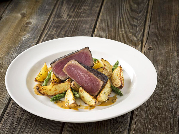 Asparagus standing at attention next to a steak so perfectly caramelized it could make a vegetarian question their life choices.
